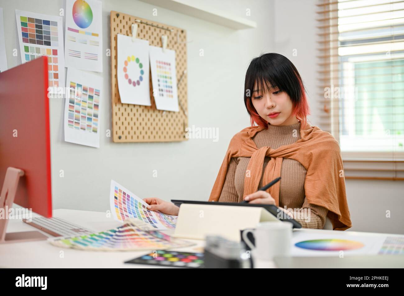 Talented young Asian female graphic designer or interior designer ...