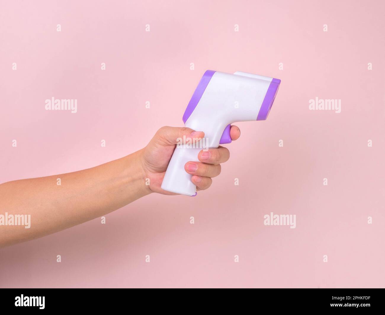 Close up of hand holding Digital Thermometer (thermometer gun), Medical ...