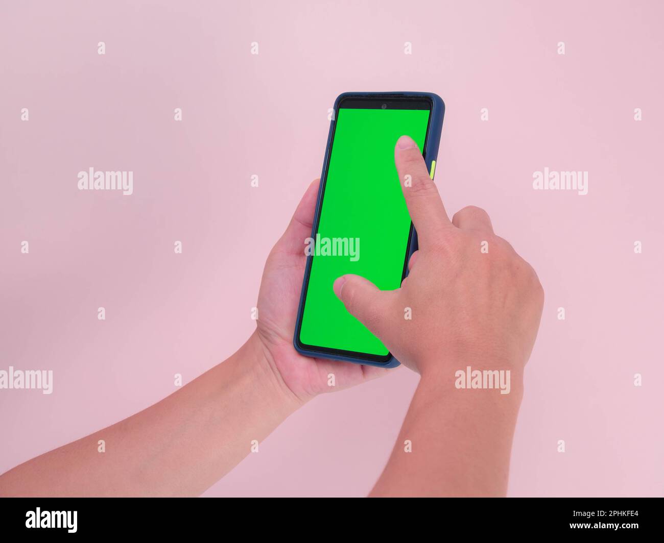 Human hand using mobile smartphone with green screen isolated on pink ...
