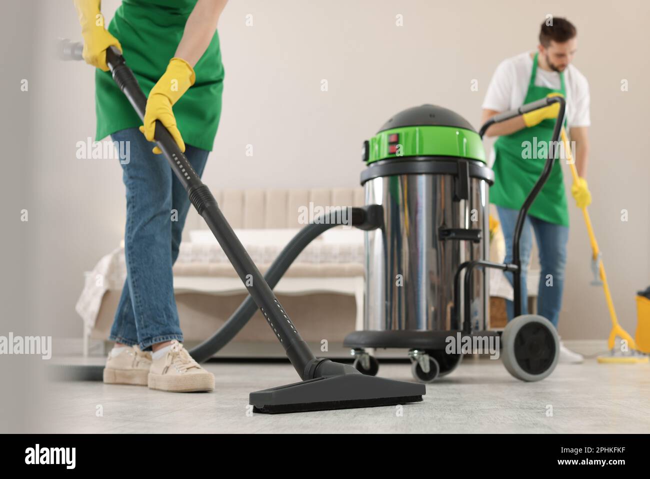 Professional janitors working in bedroom, closeup. Cleaning service ...