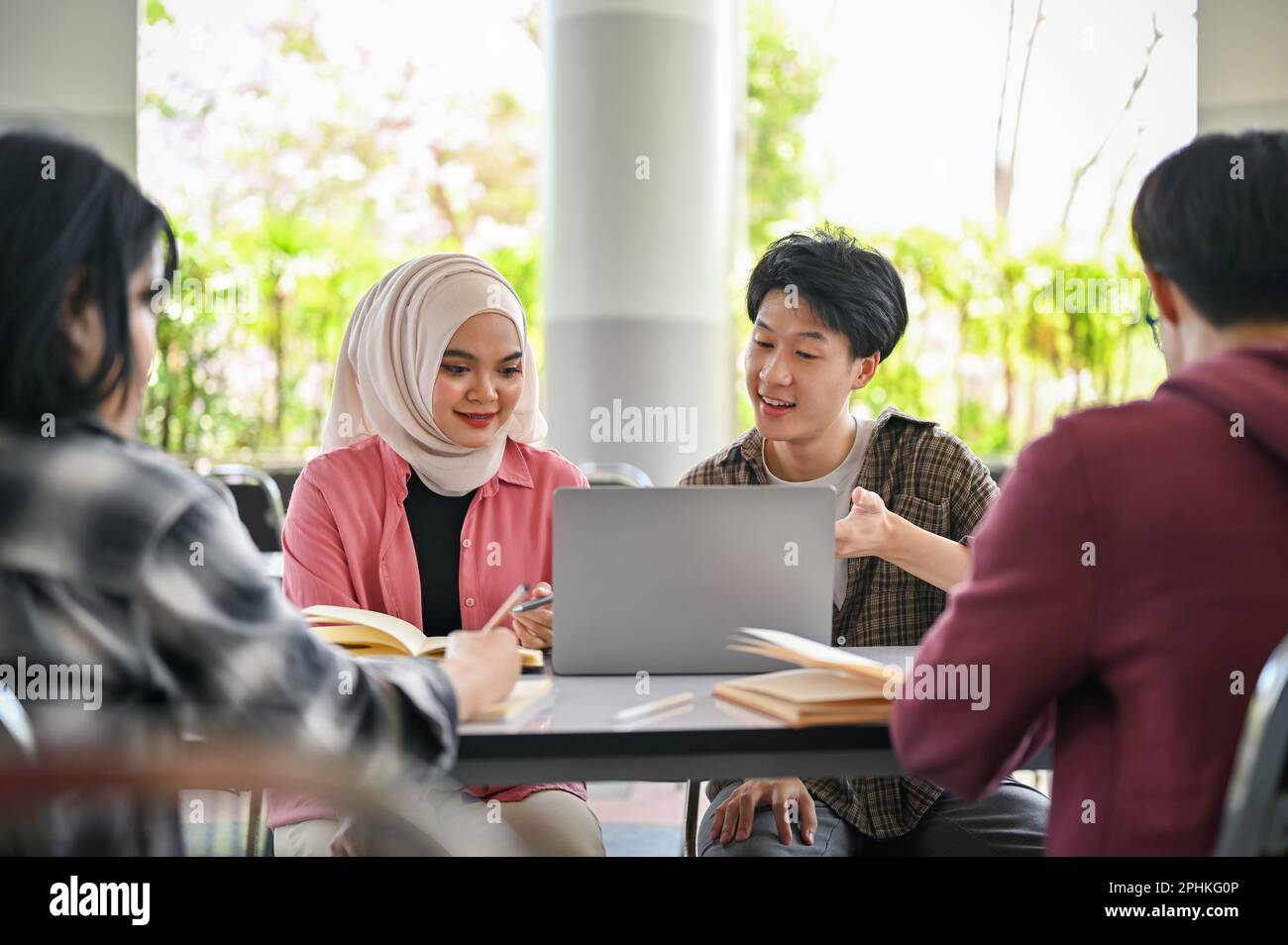 Smiling student preparing exam using hi-res stock photography and ...