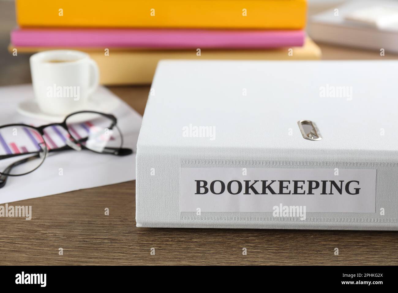 Bookkeeping folder on desk in office, closeup Stock Photo - Alamy