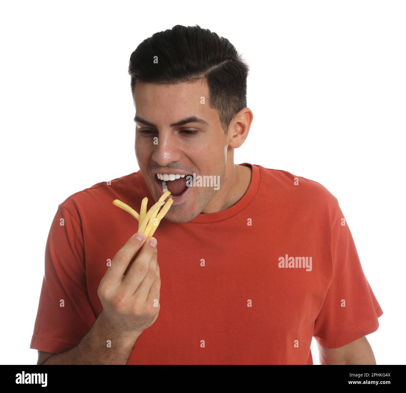 Man eating French fries on white background Stock Photo - Alamy