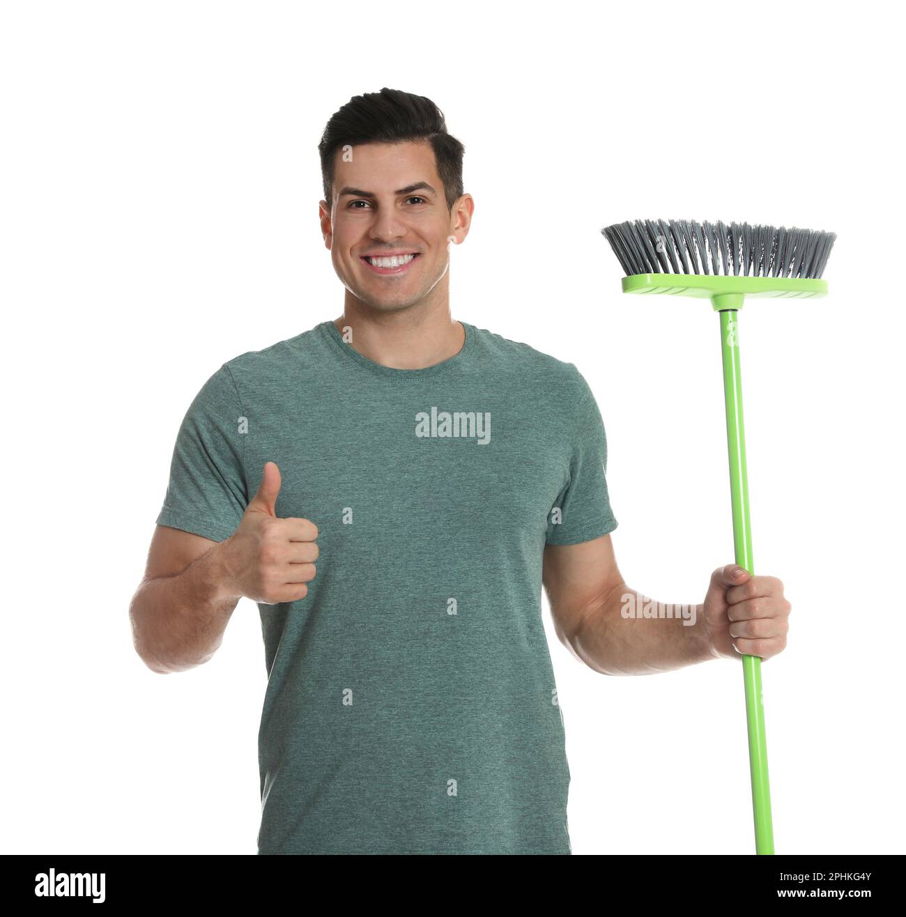 Man with green broom on white background Stock Photo - Alamy