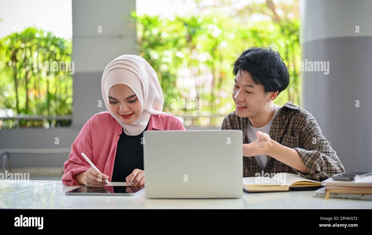 Smart and happy young Asian male college student explaining and ...