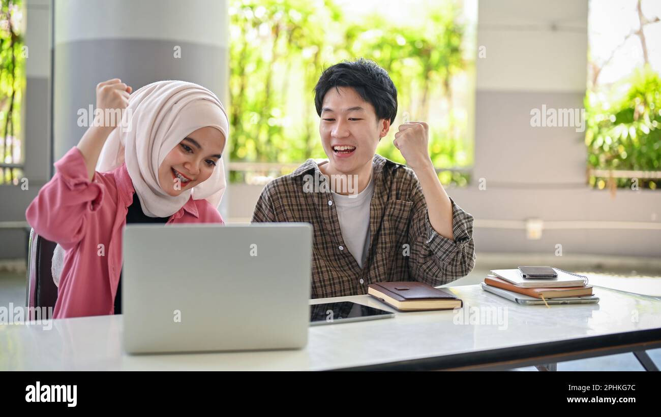 Happy and cheerful young Asian Muslim woman and Asian male college ...