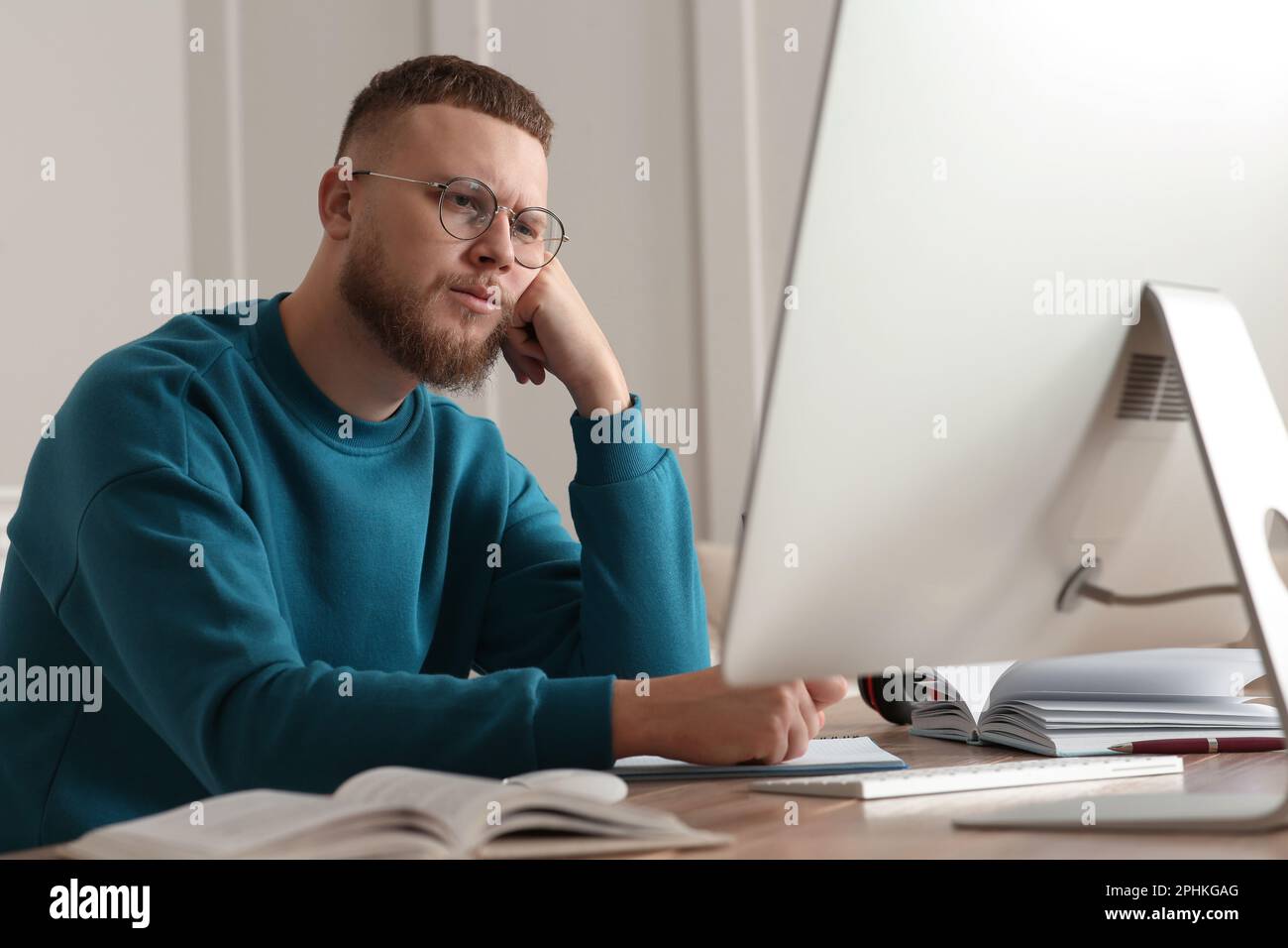 Online test. Man studying with computer at home Stock Photo - Alamy