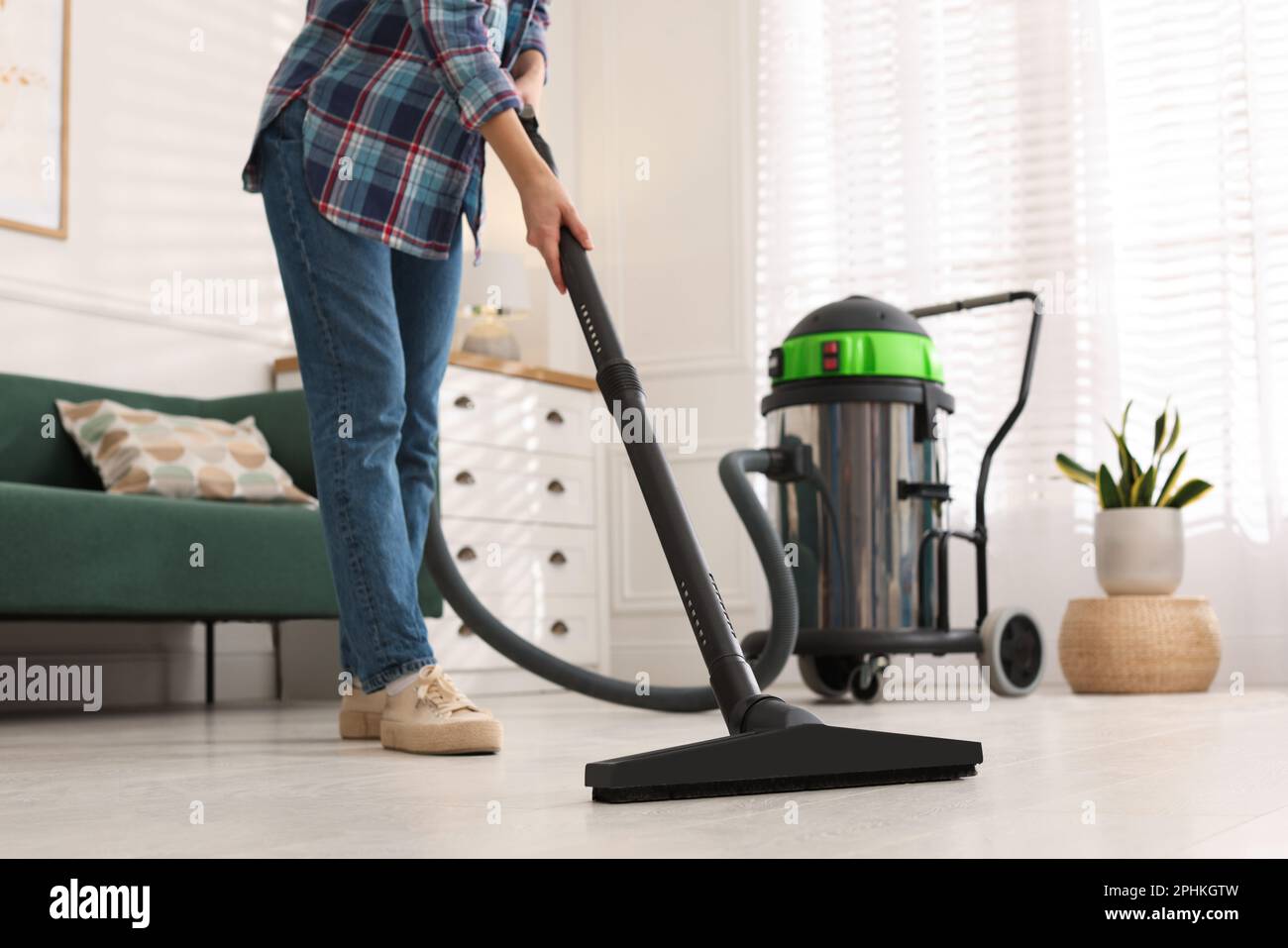Female housekeeper vacuuming floor in hi-res stock photography and ...