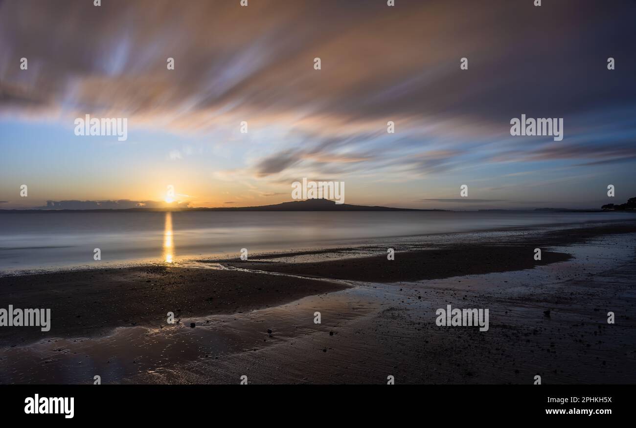 Long exposure image of sun rising over Rangitoto Island, clouds ...