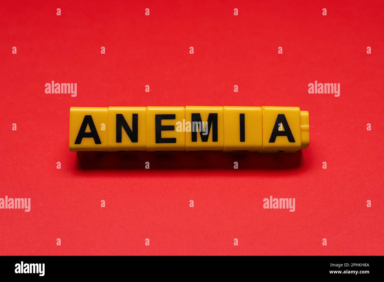 Word Anemia made of yellow cubes on red background, flat lay Stock ...