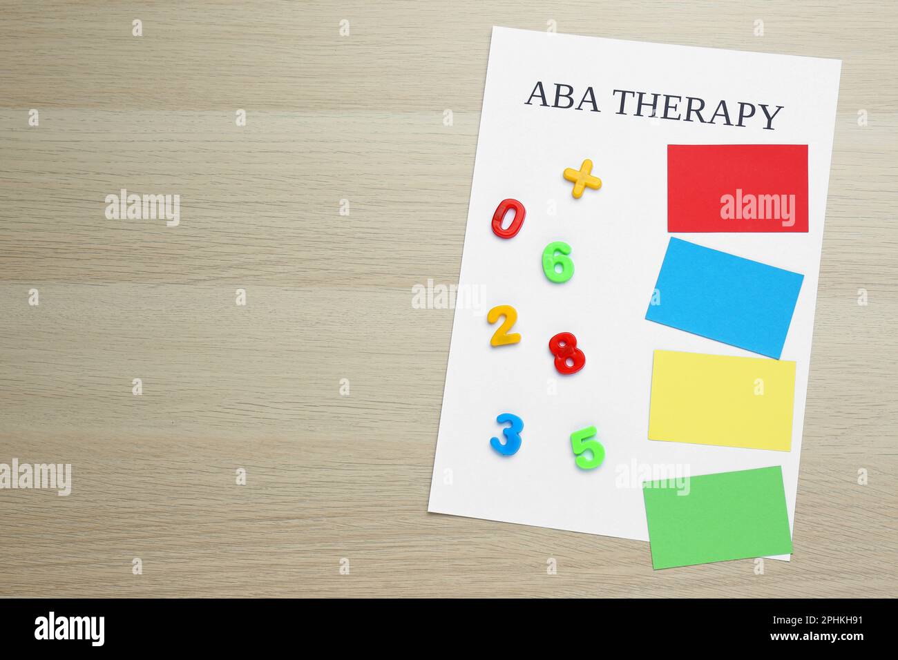Phrase ABA Therapy and different colors with numbers on white wooden ...