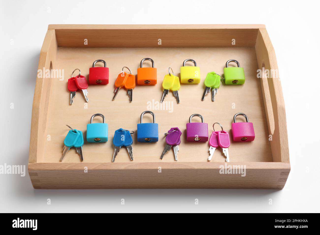 Set of colorful locks and matching keys in box isolated on white ...