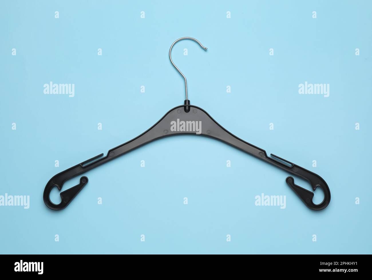 Empty hanger on light blue background, top view Stock Photo - Alamy