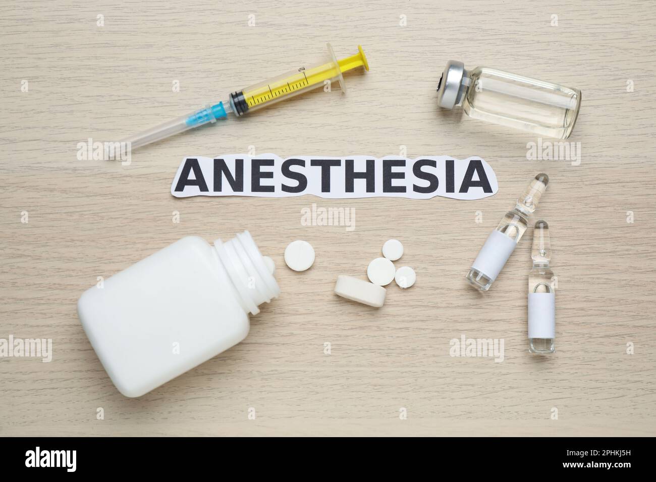 Flat lay composition with word Anesthesia and drugs on wooden table ...