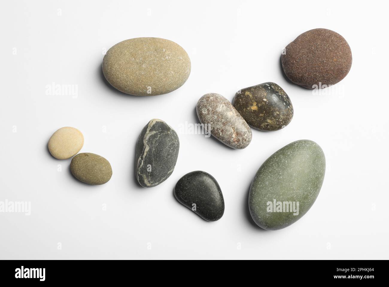Many different stones on white background, top view Stock Photo - Alamy