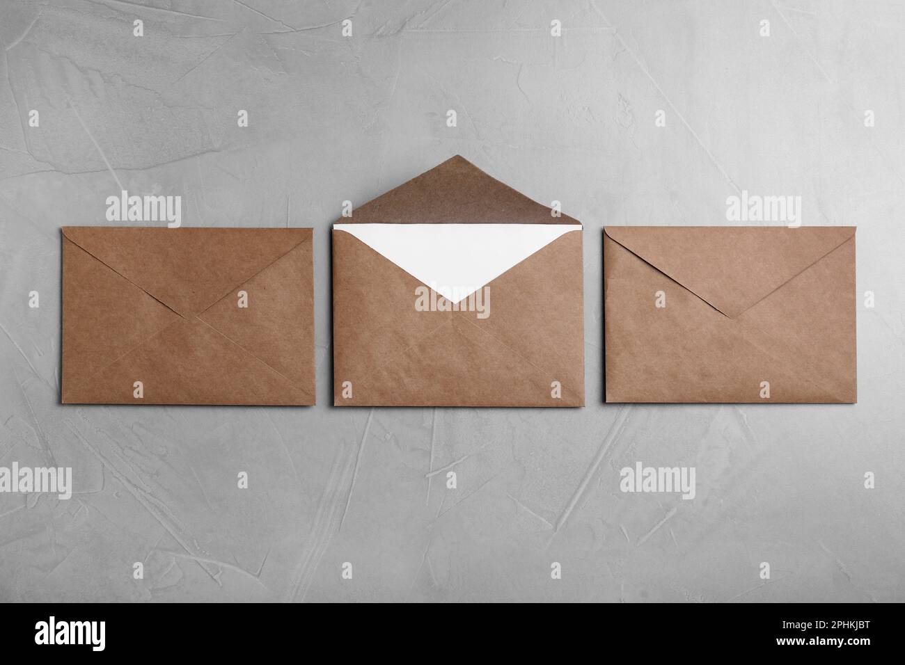 Simple brown paper envelopes on light grey table, flat lay Stock Photo ...