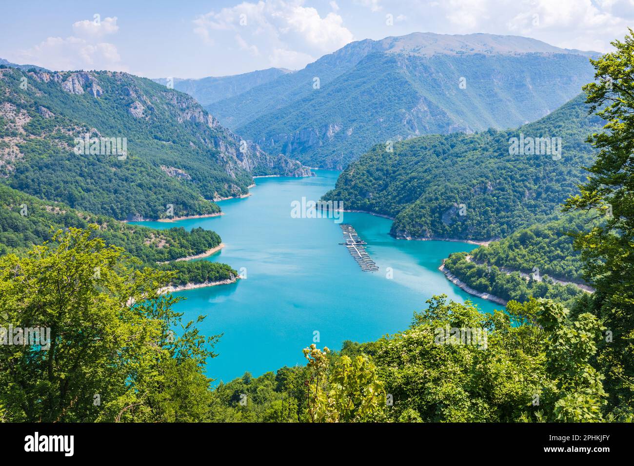 Aerial view of Piva lake or Pivsko Jezero between hills covered with ...