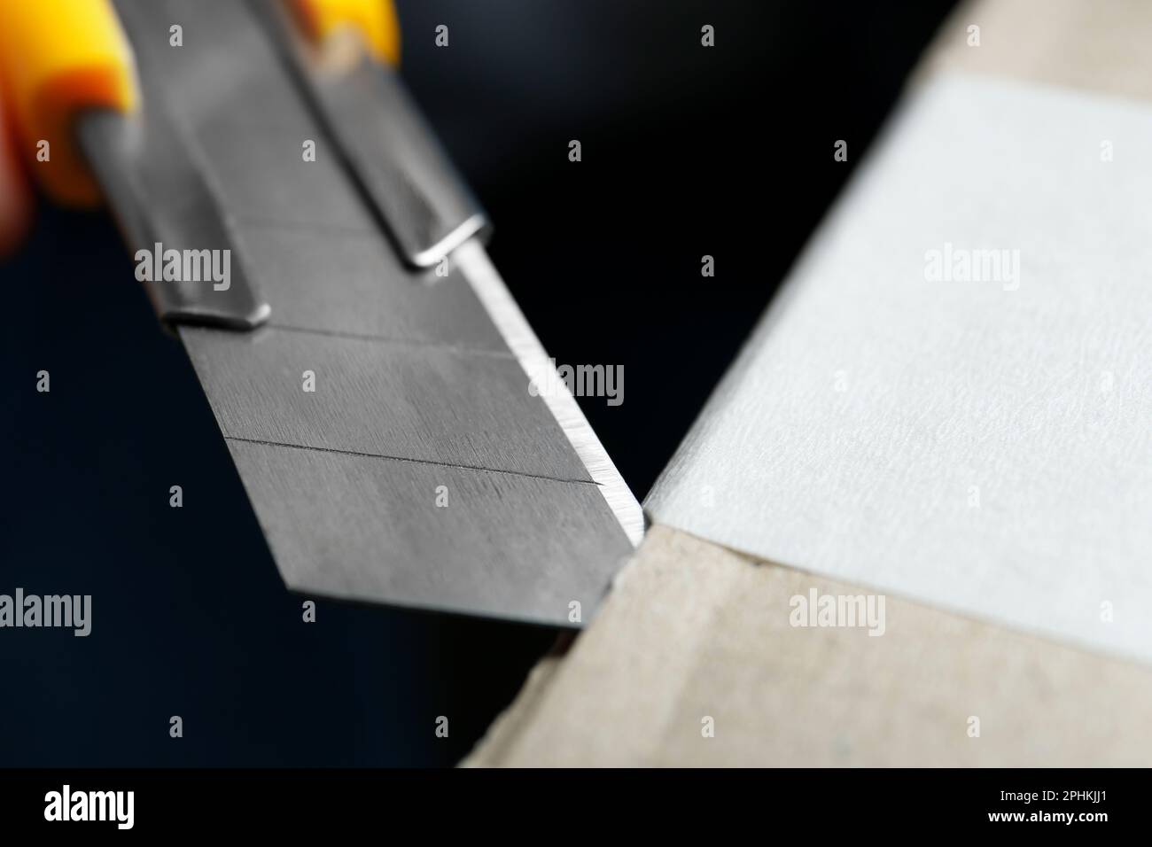 Using utility knife to open parcel, closeup Stock Photo - Alamy