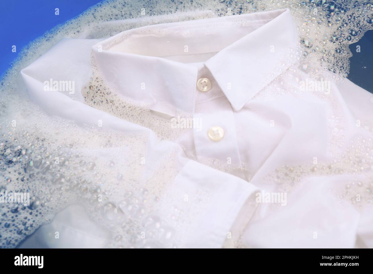 White shirt in suds, closeup. Hand washing laundry Stock Photo - Alamy