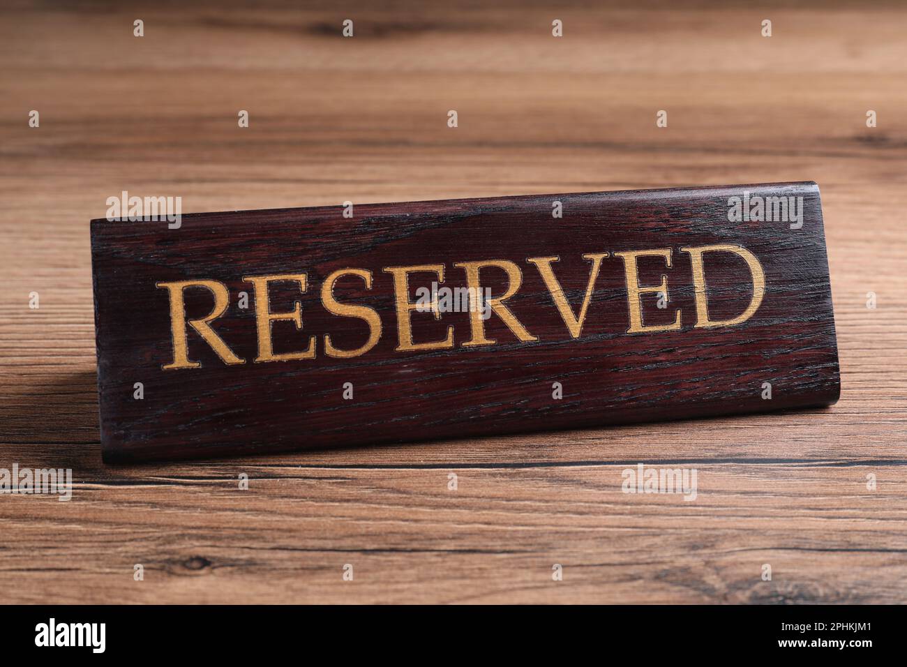 Elegant sign RESERVED on wooden surface. Table setting element Stock ...