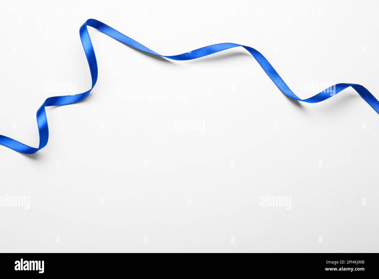 Beautiful blue ribbon on white background, top view. Space for text ...