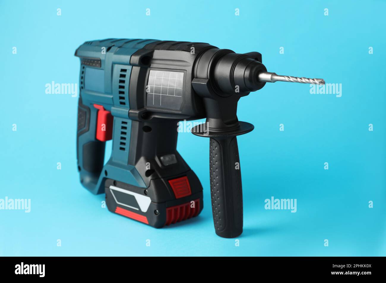 Modern electric power drill on light blue background Stock Photo - Alamy