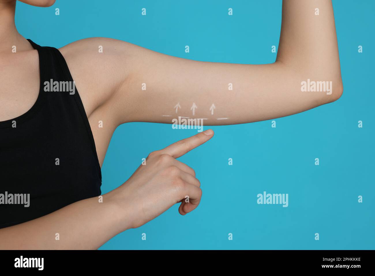 Slim woman with thin arm on light blue background, closeup. Weight loss ...