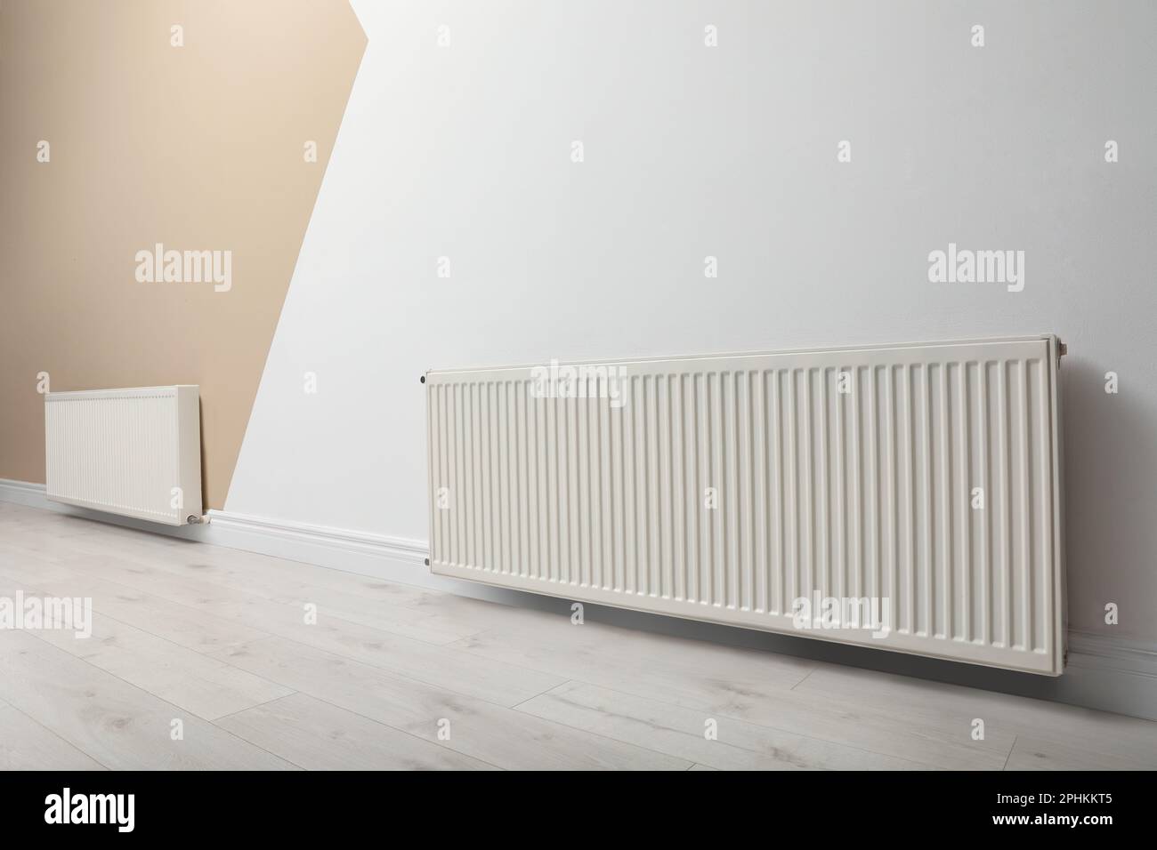 Modern radiators on color wall indoors. Central heating system Stock ...