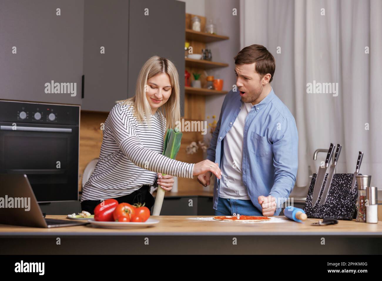 Leave Me Alone. A woman is preparing food, and a man is talking to her ...