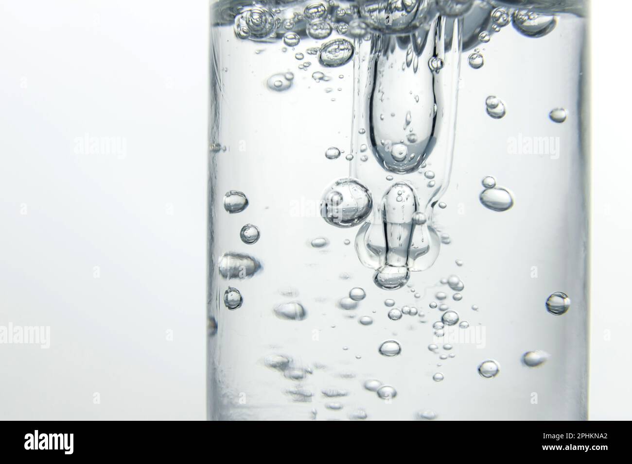 Pipette in Cosmetic serum bottle. A bubble of air in a jar. Macro photo ...