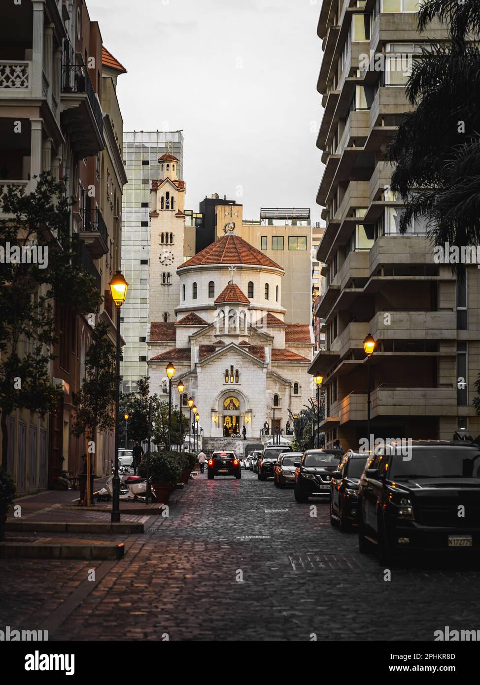 A bustling street in Beirut, Lebanon lined with parked cars on both ...