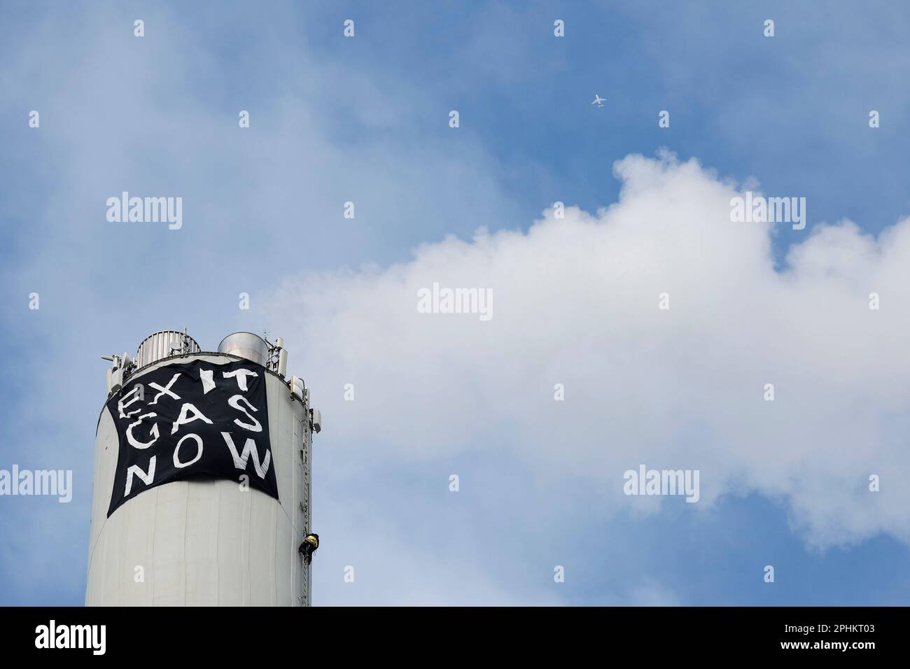 Erlangen, Germany. 29th Mar, 2023. A climate activist attaches a ...