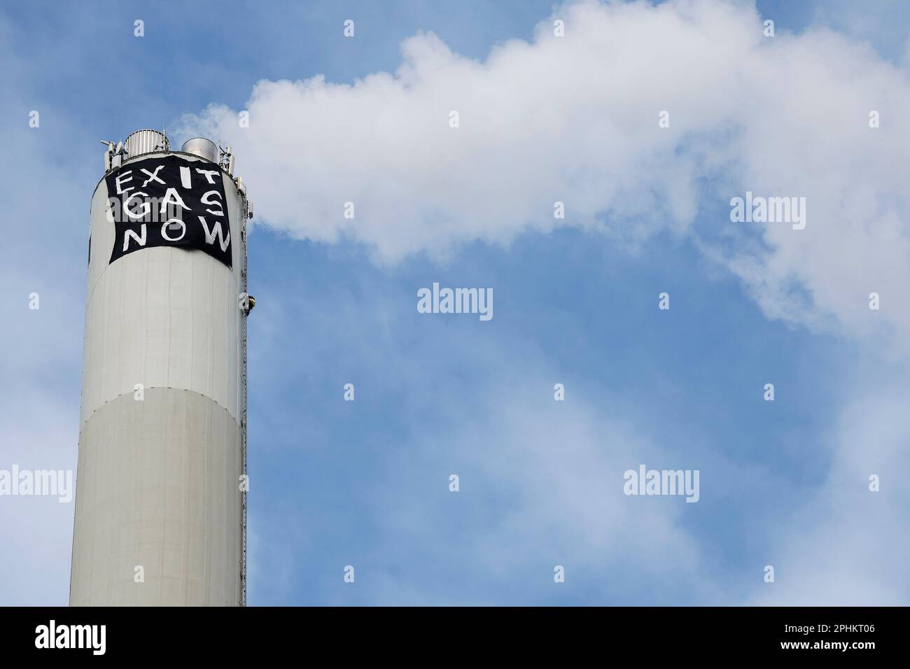 Erlangen, Germany. 29th Mar, 2023. A climate activist attaches a ...