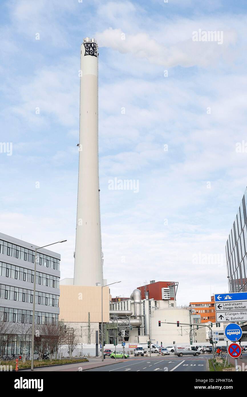 Erlangen, Germany. 29th Mar, 2023. A climate activist attaches a ...
