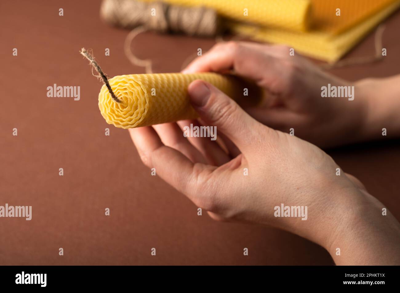 Beeswax honeycomb candle sheets and jute thread on brown background ...
