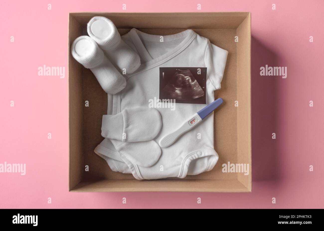 Box with baby stuff and pregnancy test Stock Photo - Alamy