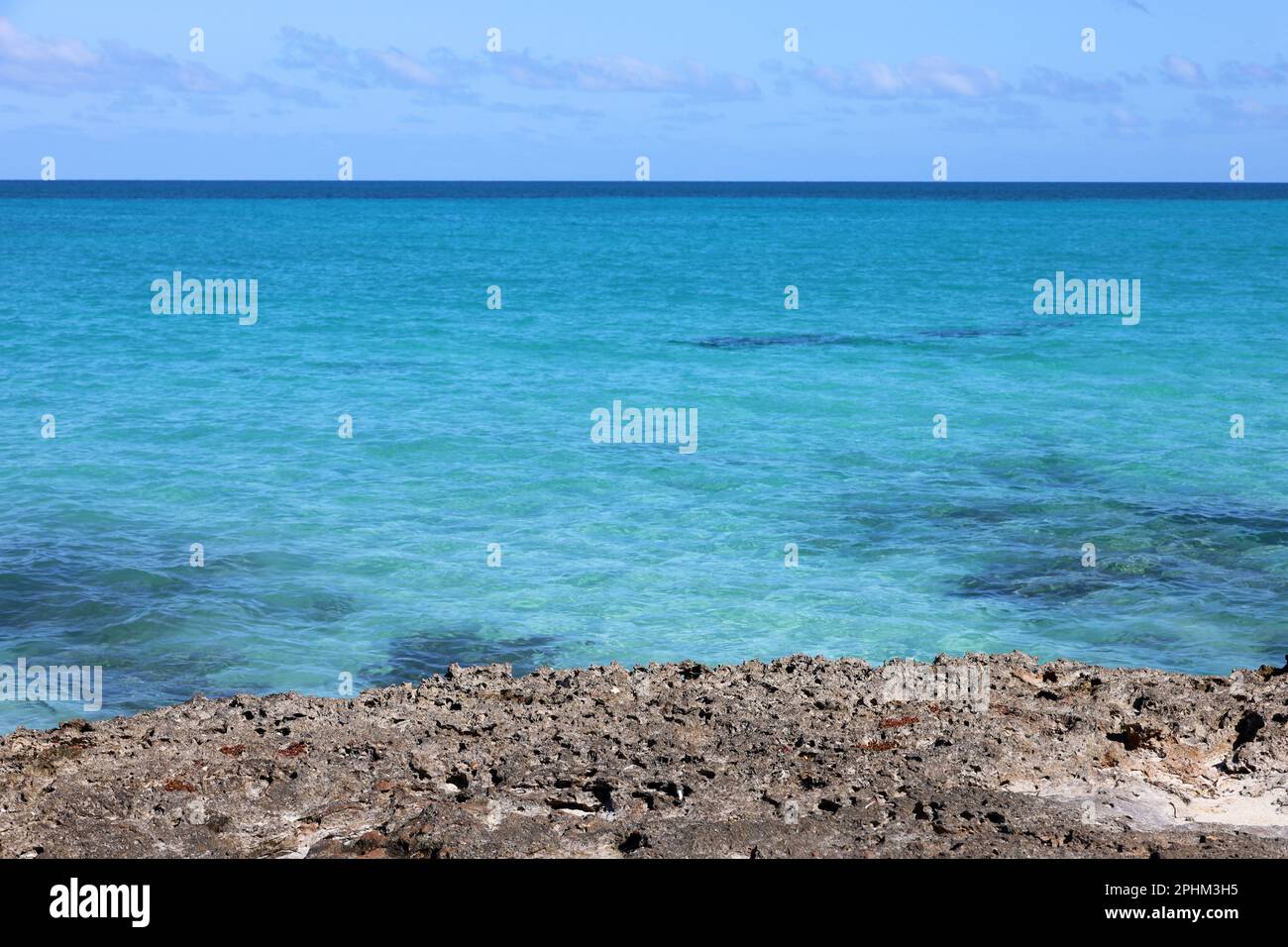 View to blue ocean from stone coast. Seascape with azure water Stock ...