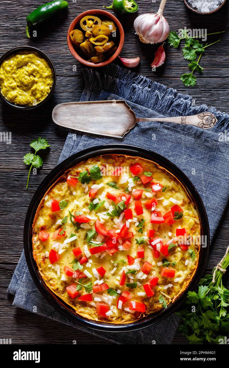 Green Chile Enchilada Casserole of corn tortillas layered with refried ...