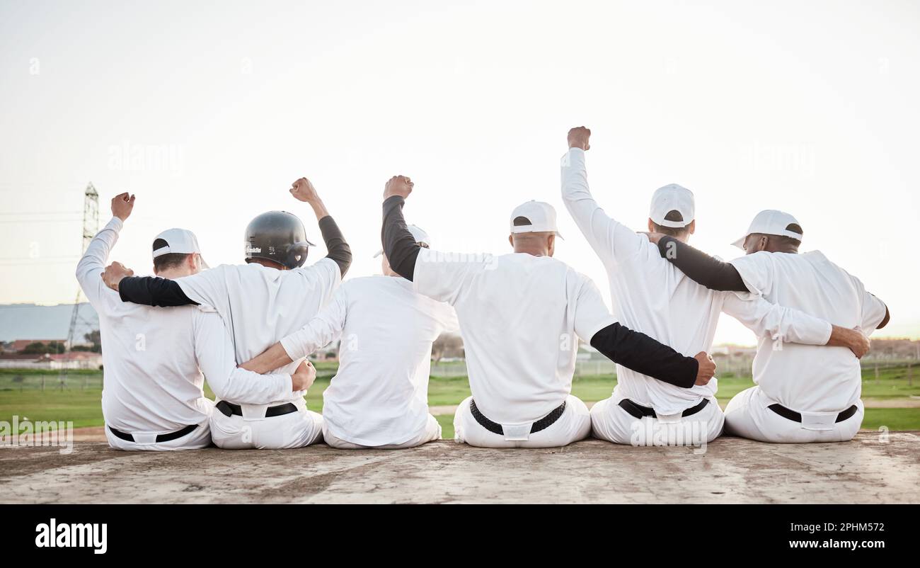 Baseball, team and winner with fist pump and men on pitch, athlete ...