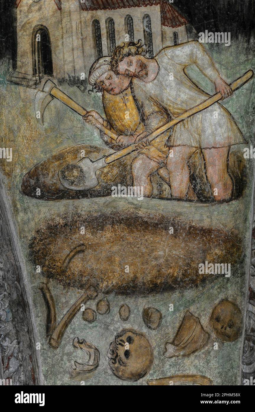 Grave diggers unearth old skulls and bones in a churchyard. Late Gothic ...