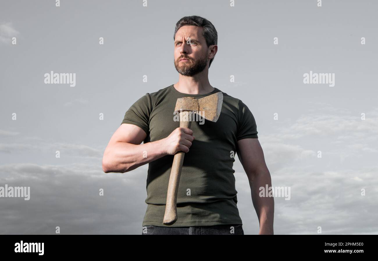 strong man with axe. confident man hold ax. brutal man on sky ...