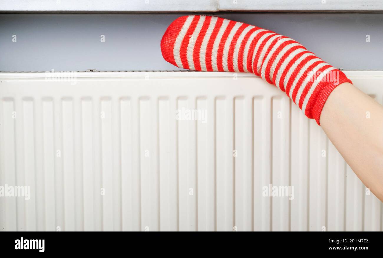 Warming Feet on White Radiator, Man Warms his Feet at Home, Cold Winter ...