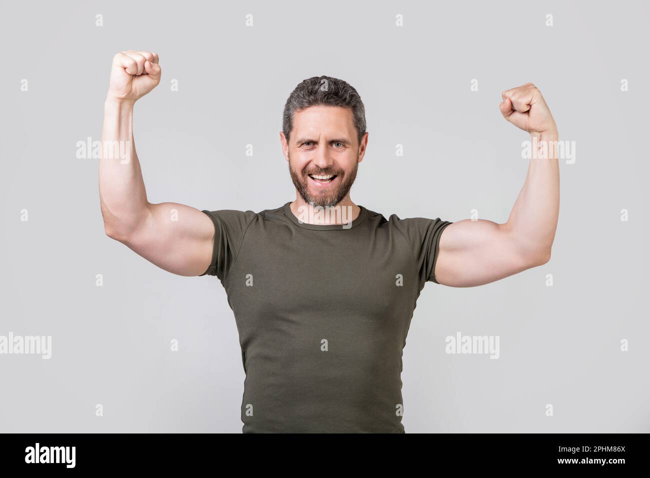 successful strong muscular man isolated on grey background. strong ...