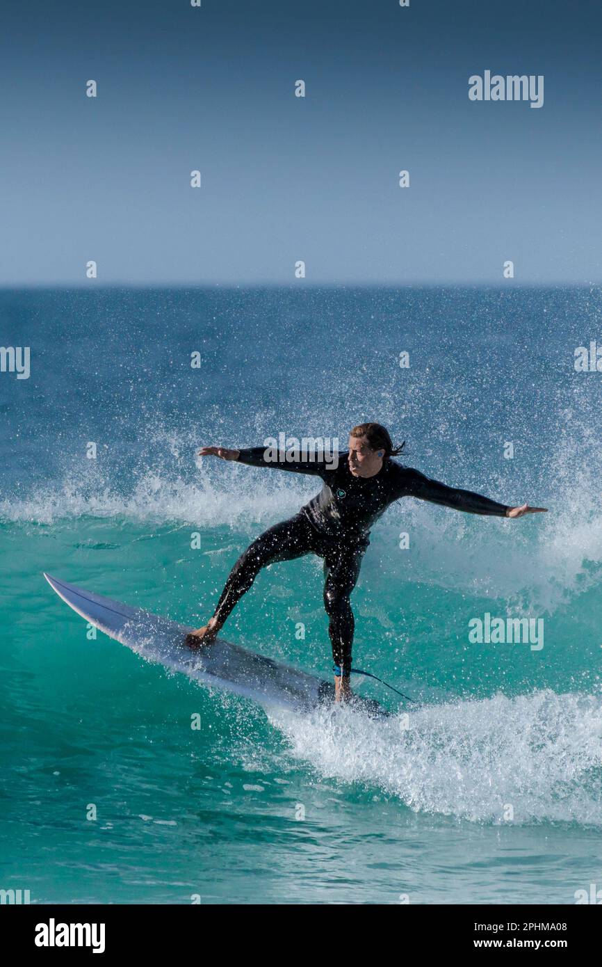 Spectaular surfing action as a male surfer rides a wave at Fistral in ...