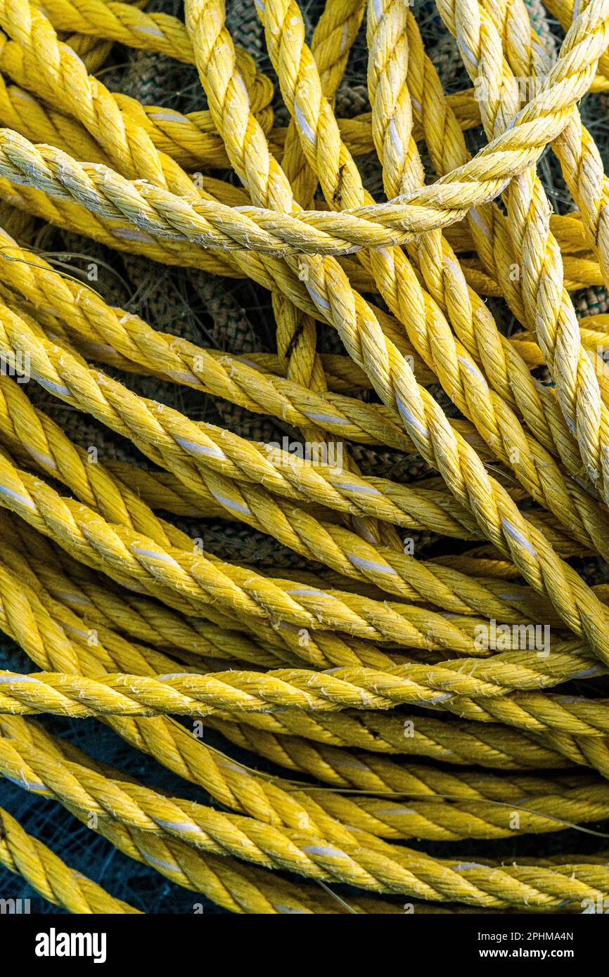 Coiled yellow rope Stock Photo - Alamy