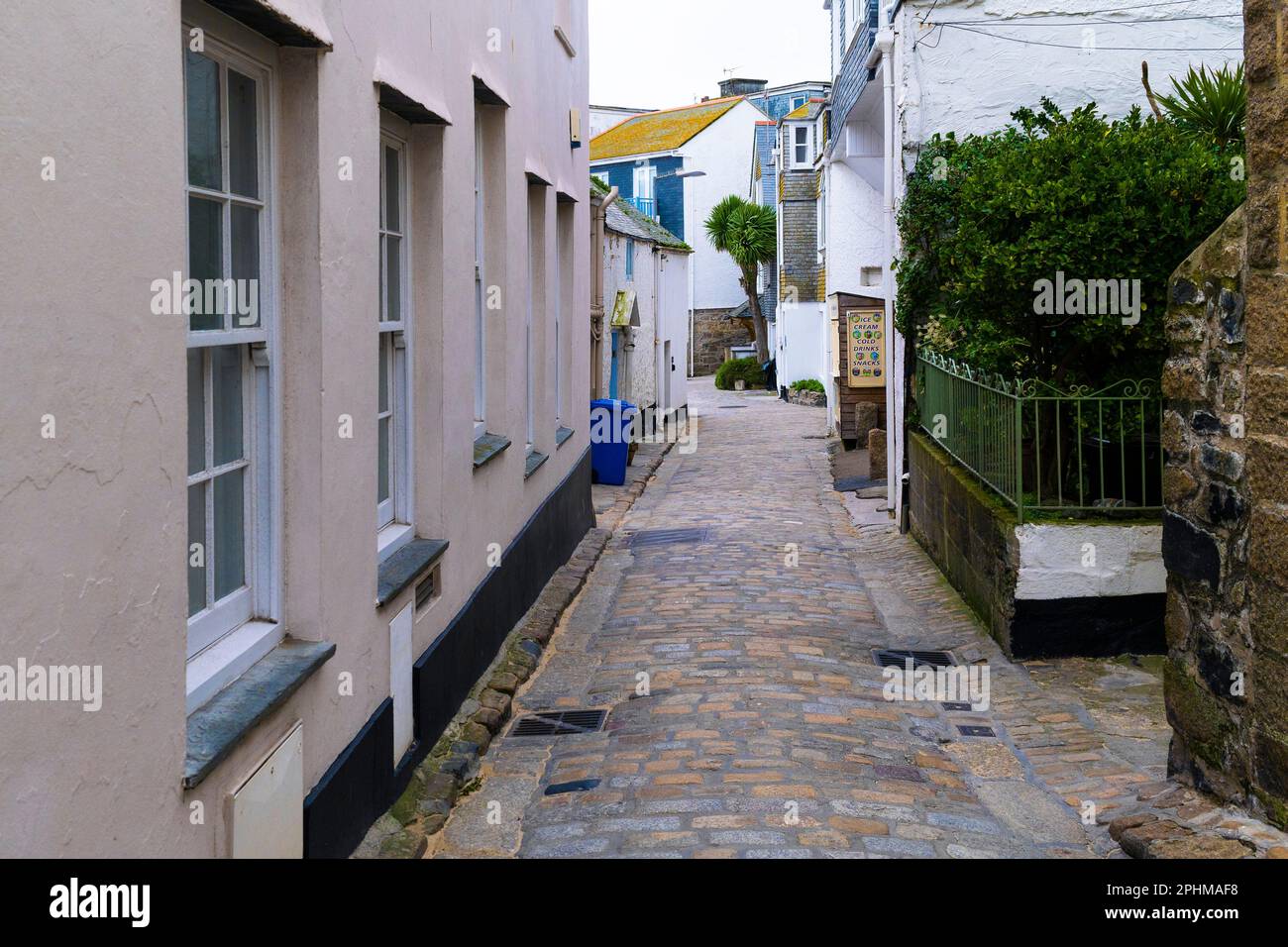 A narrow quaint deserted cobbled street in St Ives during the off ...