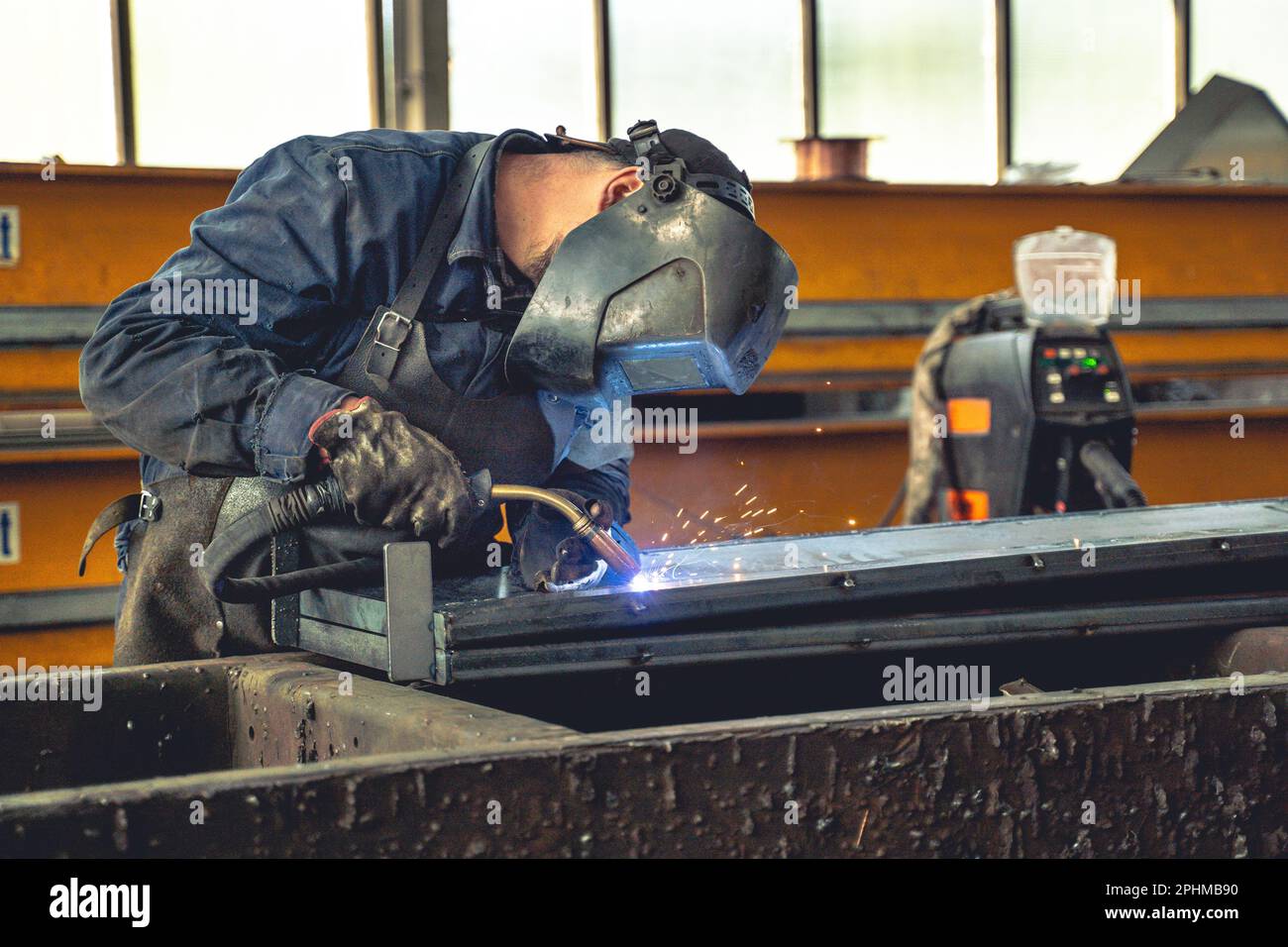 Skilled mechanic using welding machine hi-res stock photography and ...
