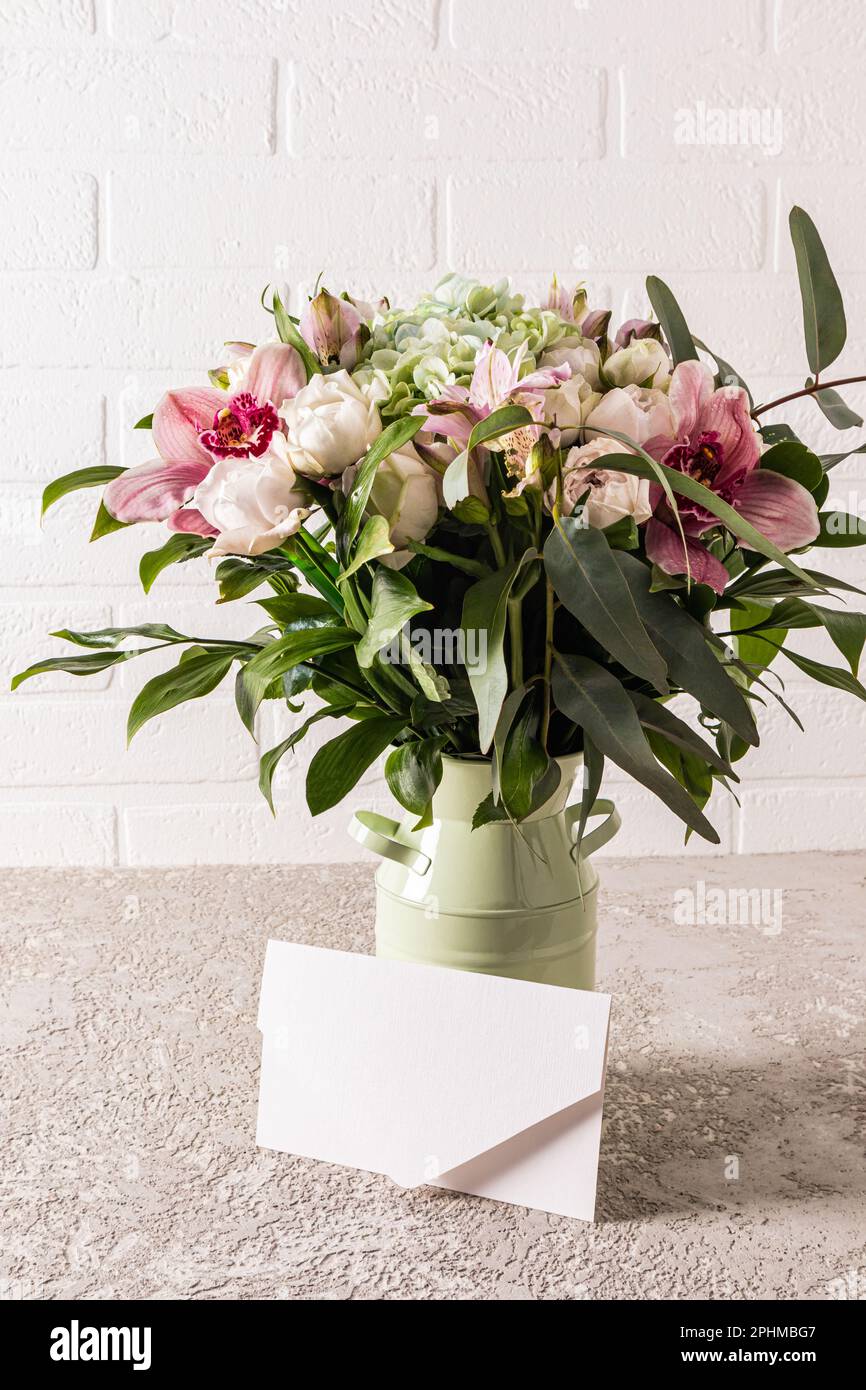 a delicate bouquet of fresh astromeria flowers in a decorative metal ...