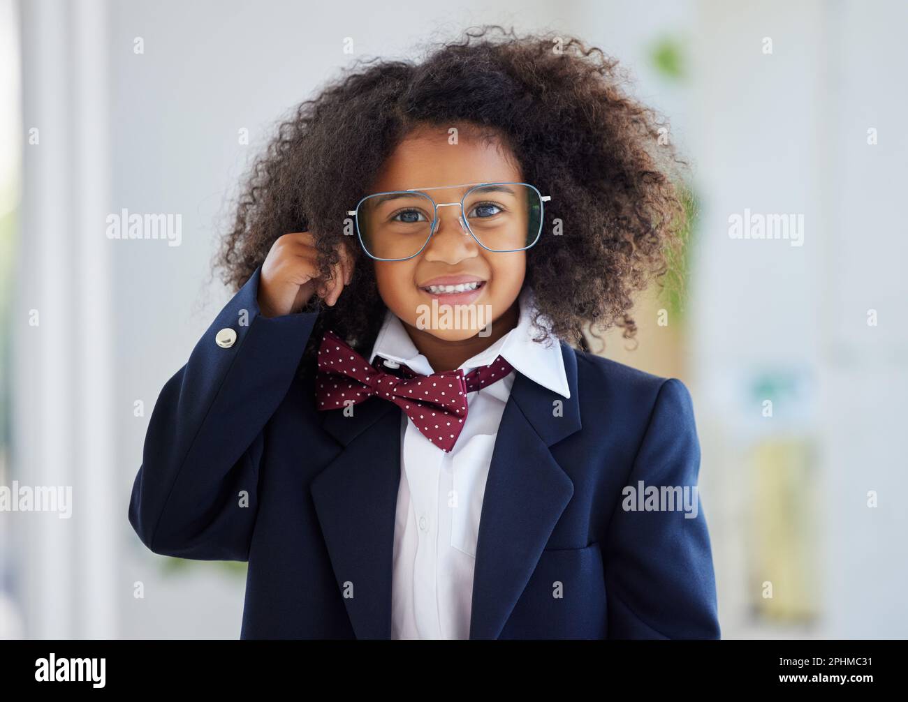 Happy, portrait and a child dressed as an employee, playing in the ...