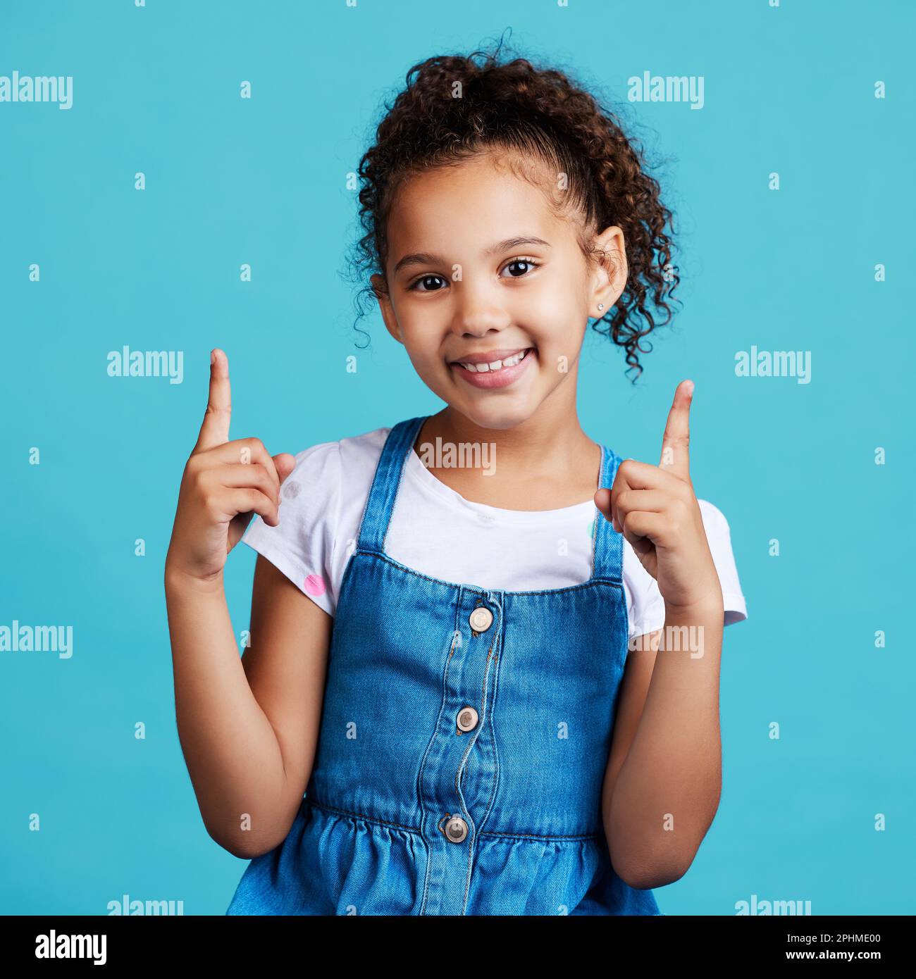 Portrait, point and mockup with a girl on a blue background in studio ...